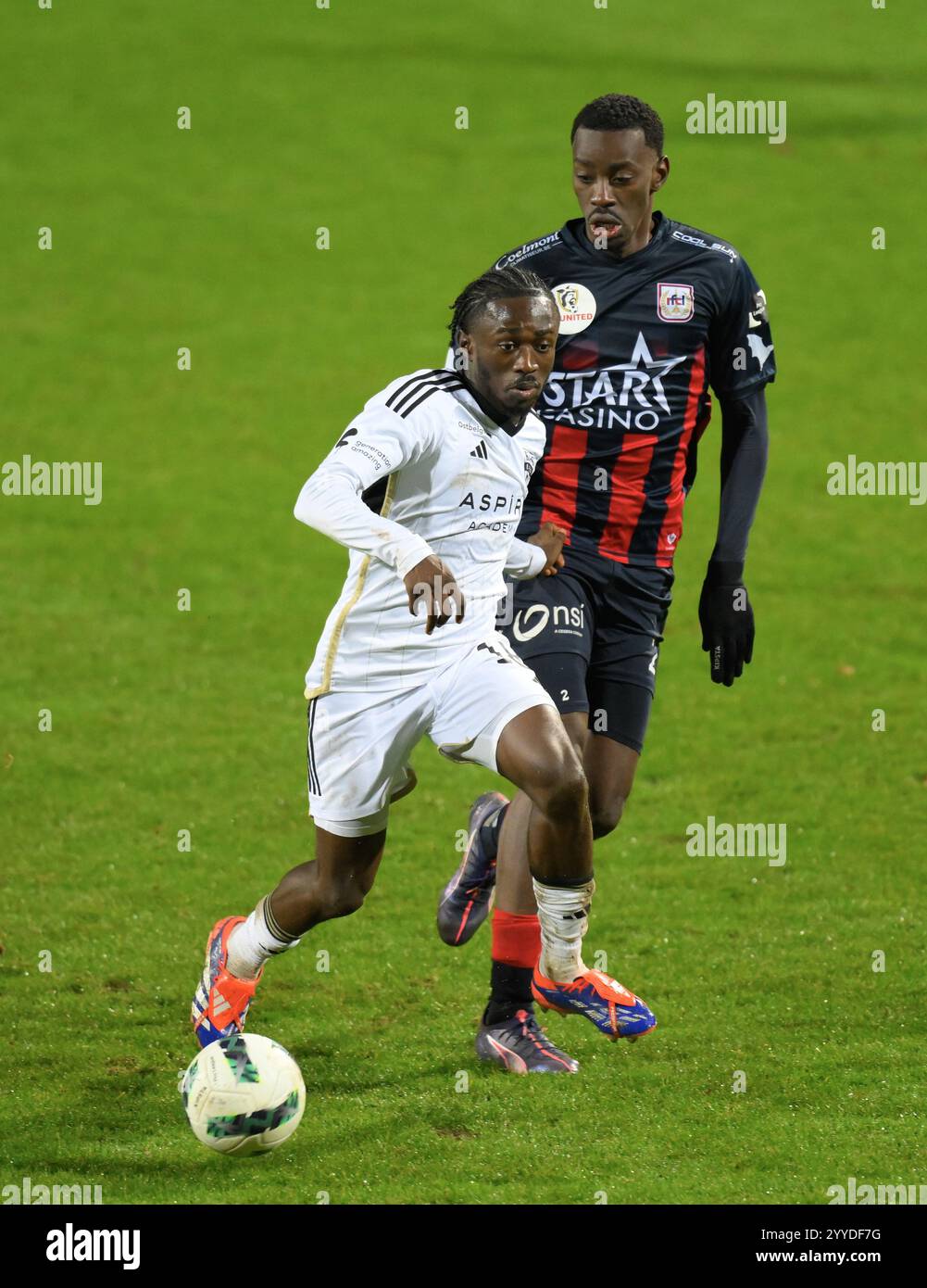 Eupen, Belgium. 21st Dec, 2024. Eupen's Amadou Keita and Liege's ...