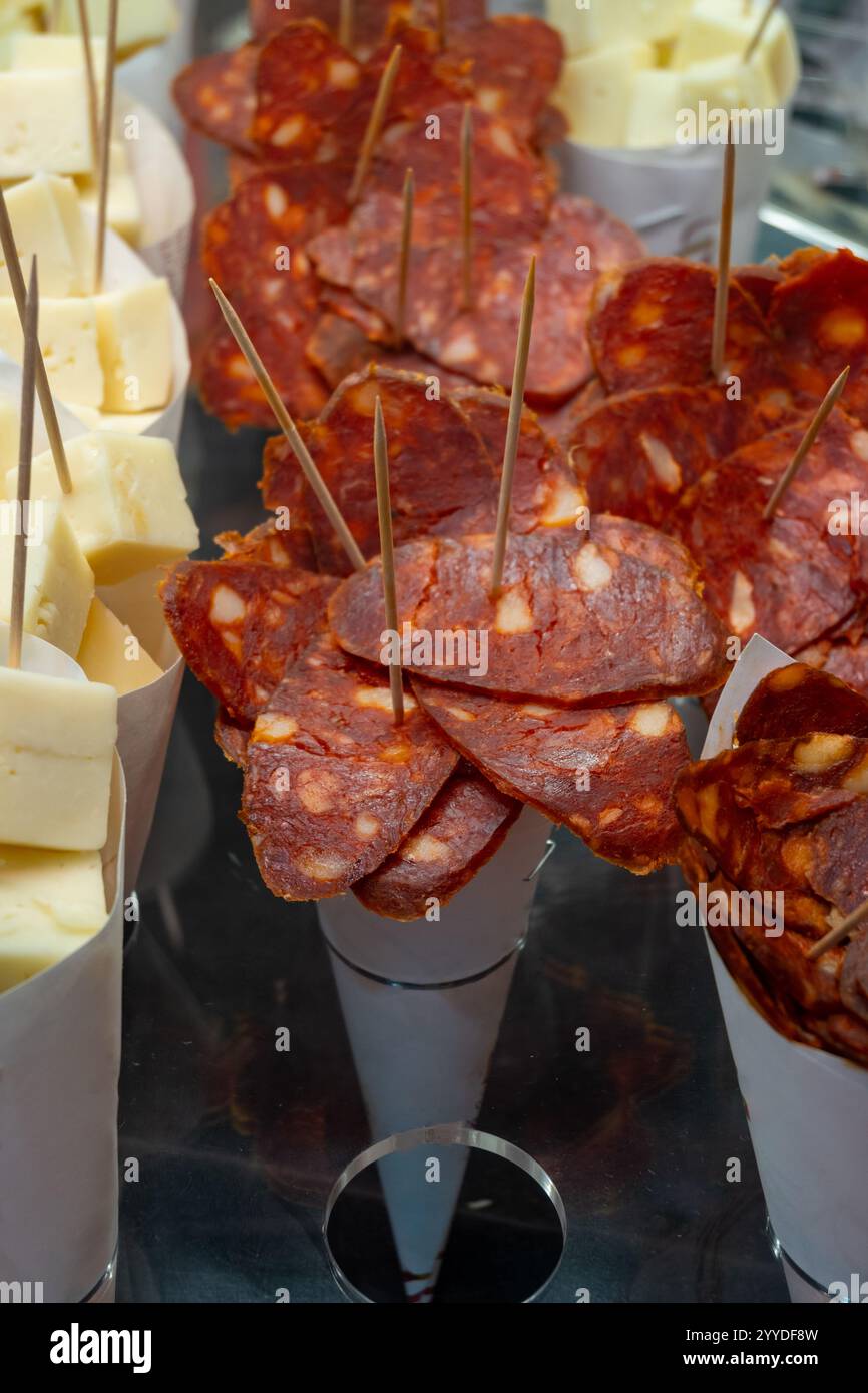 Spanish street food, snack, tapas, sliced sausages, cheese, dry-cured ...