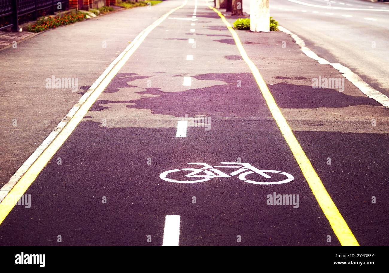 Bike Lane. Yellow and white marking on a bicycle path Stock Photo - Alamy