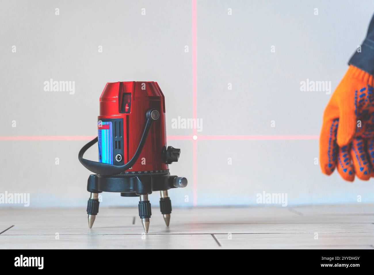 Worker and Bubble,laser level. measuring with red laser level ...