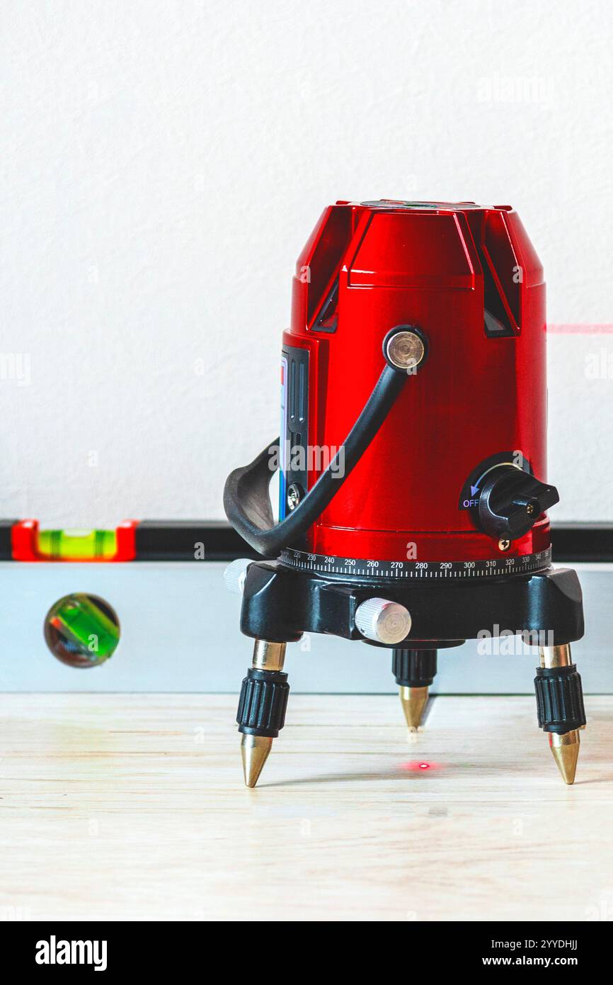 Laser level and Bubble levels, lines on the wall. measuring with red ...