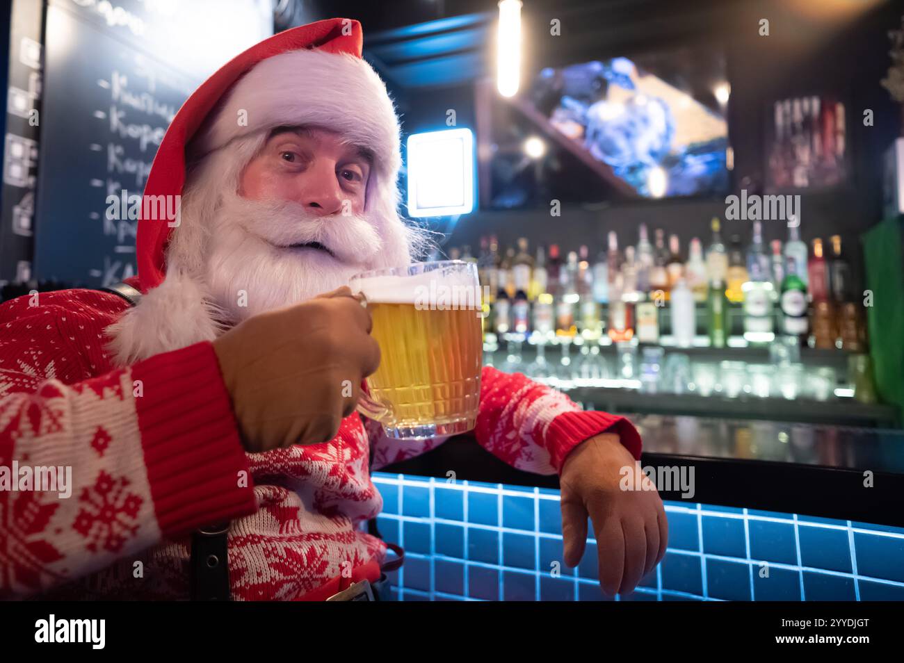 Santa Claus drinking beer at a bar Stock Photo - Alamy