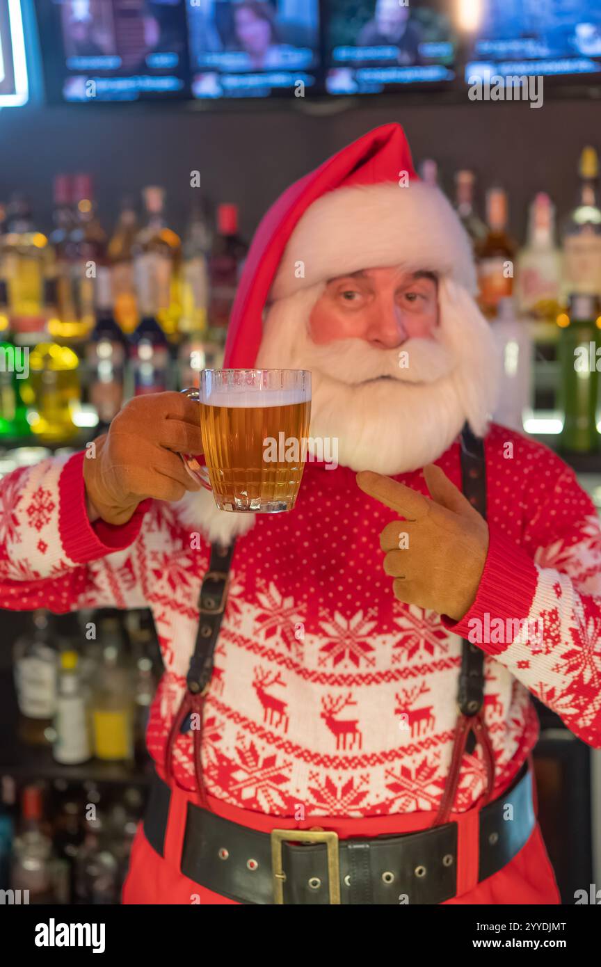Santa Claus drinking beer at a bar Stock Photo - Alamy