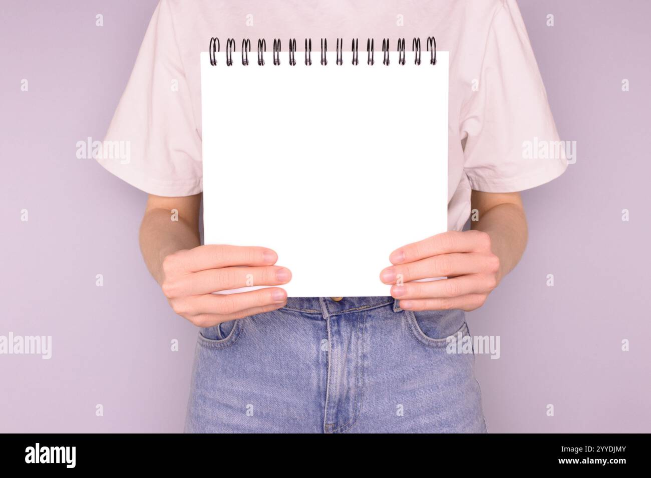 Unrecognizable woman hold in hands notepad. Blank mockup in front of ...