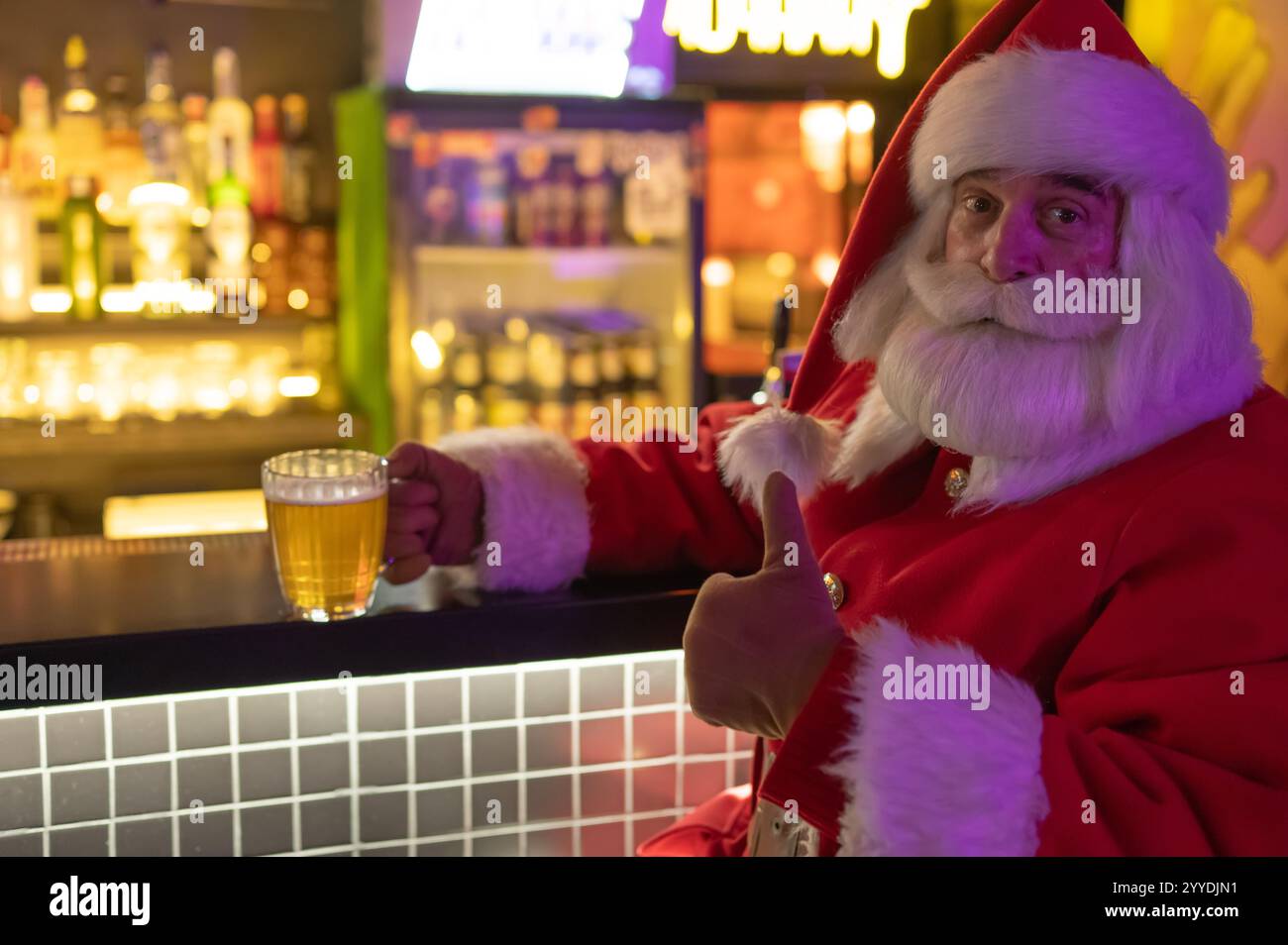 Santa Claus drinking beer at a bar Stock Photo - Alamy