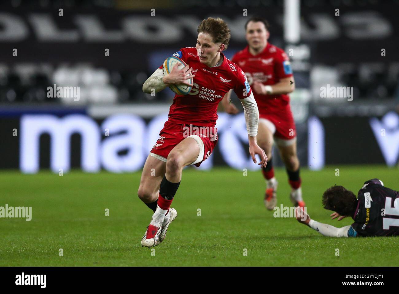 Swansea, UK. 21 December, 2024. Ellis Mee of Scarlets makes a break ...