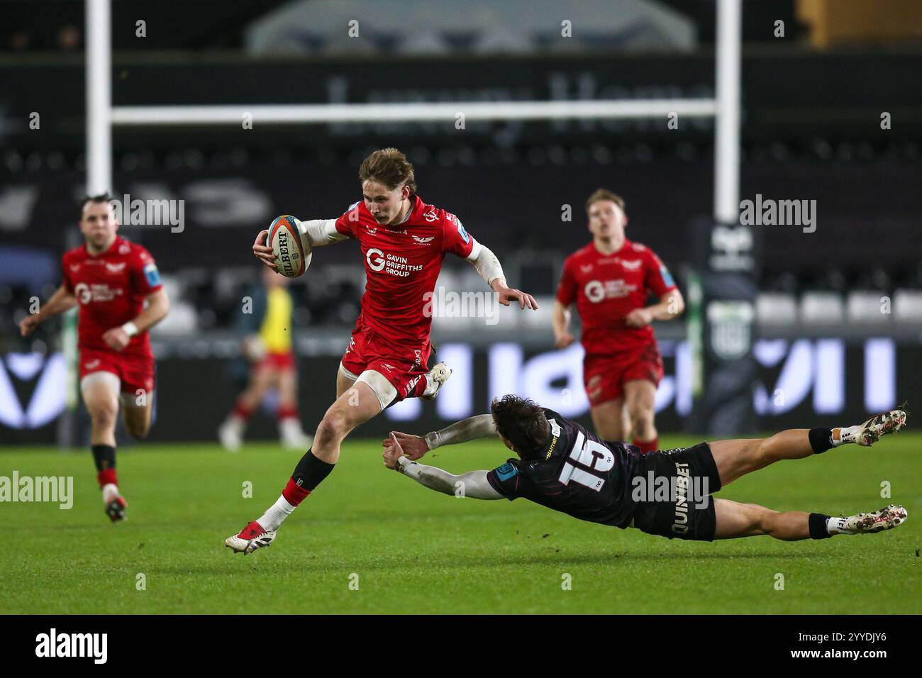 Swansea, UK. 21 December, 2024. Ellis Mee of Scarlets gets past Jack ...