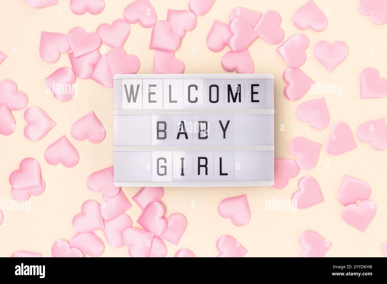 Welcome baby girl. Lightbox with letters and pink confetti in a heart ...