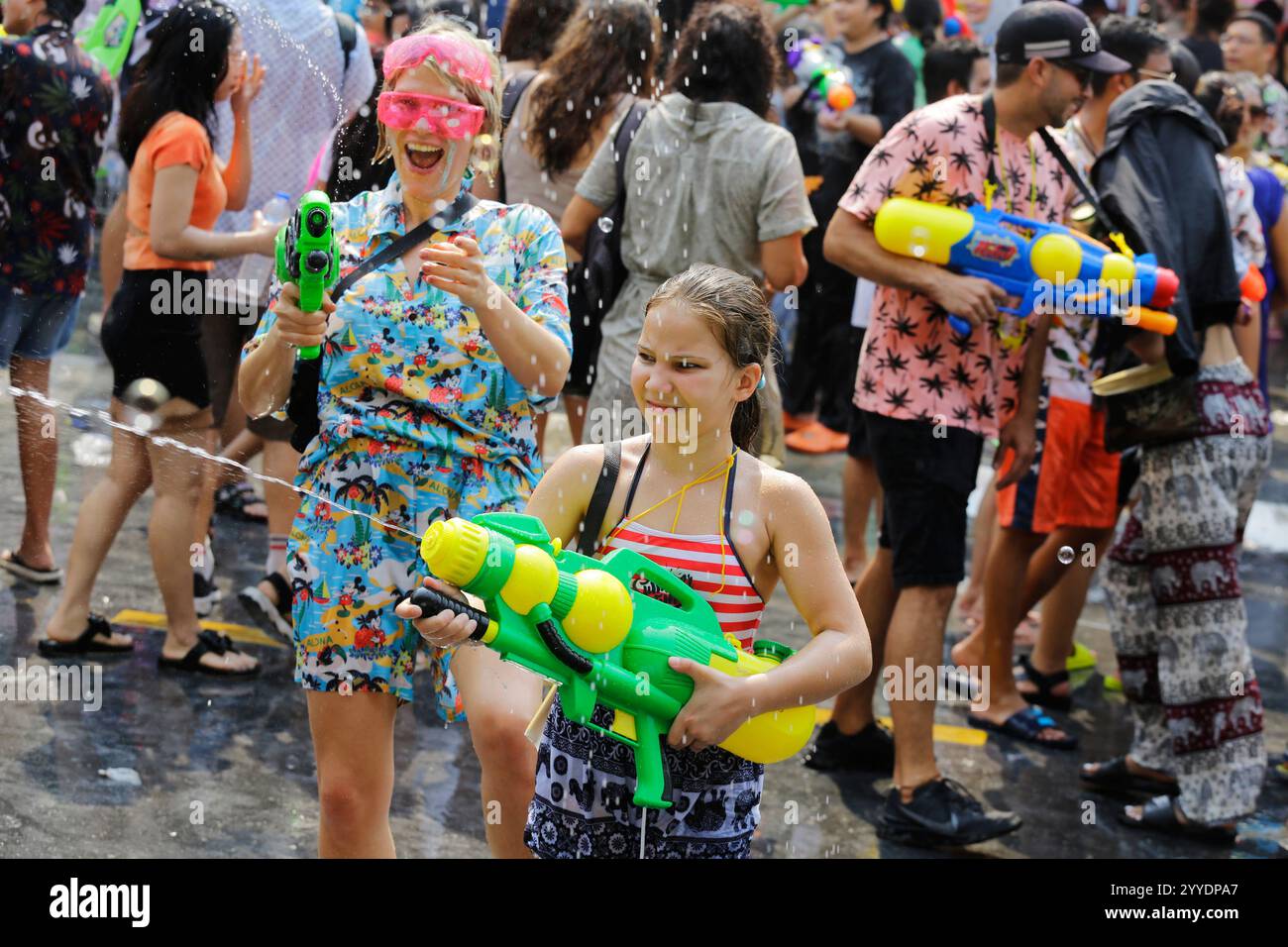 Bangkok, Thailand - April 13, 2023: Foreigners splash water using water guns during Songkran ...