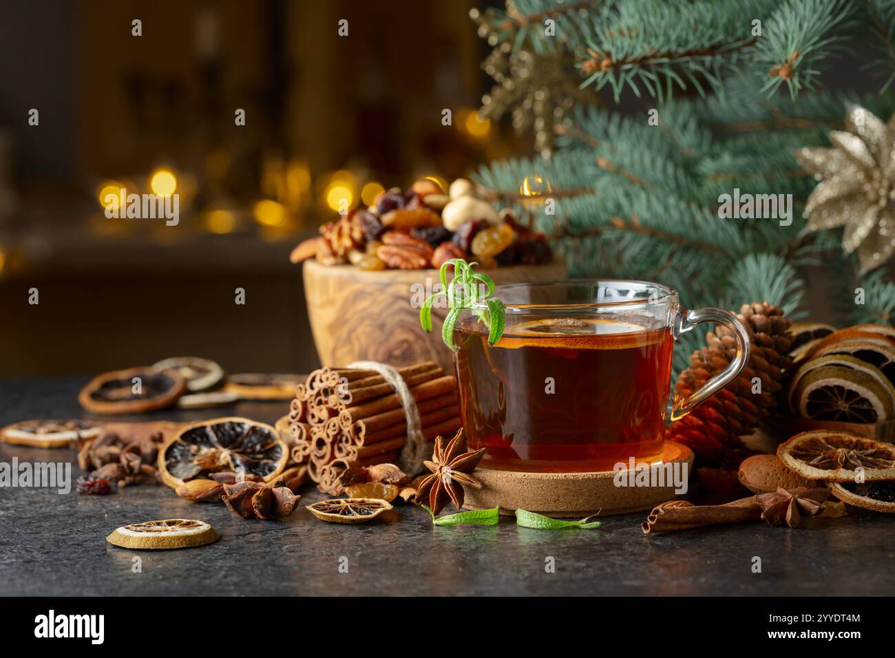 Tea with spices and dry fruits on a kitchen table. Christmas still-life ...