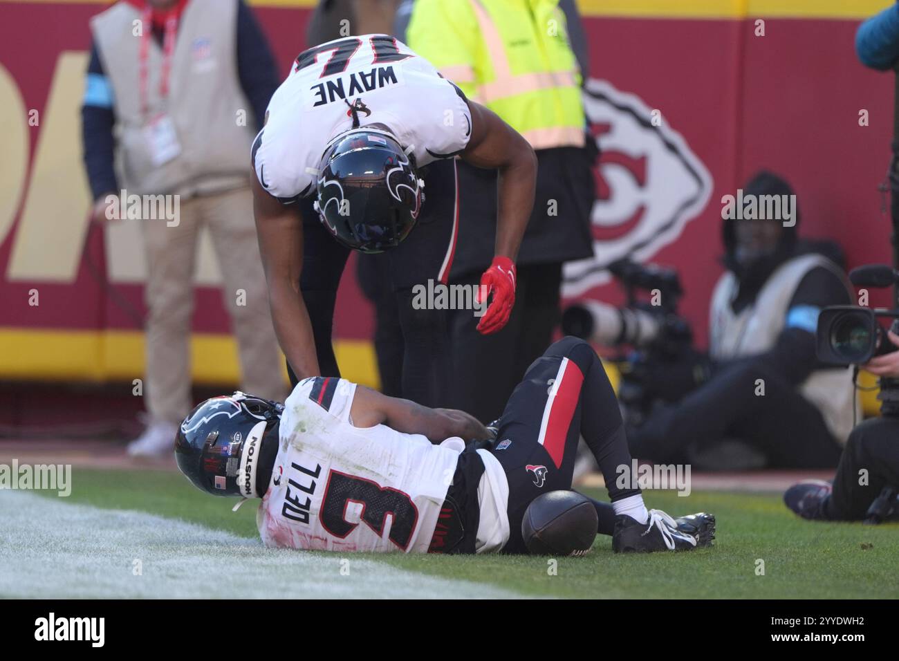 Houston Texans wide receiver Tank Dell, grabs his knee while being ...