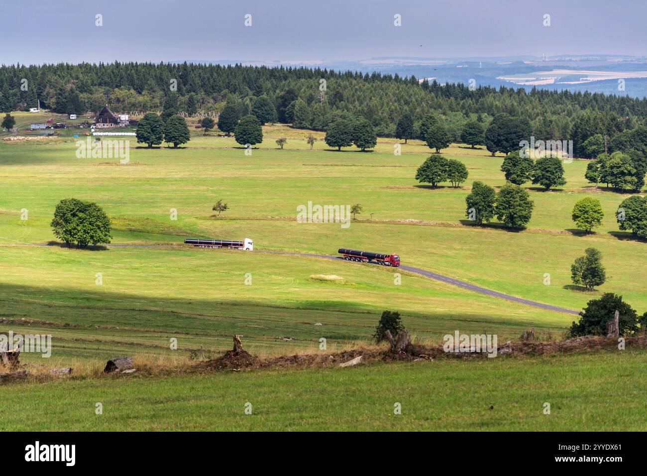 Truck transporting large steel oil and gas pipes, excessive load and ...