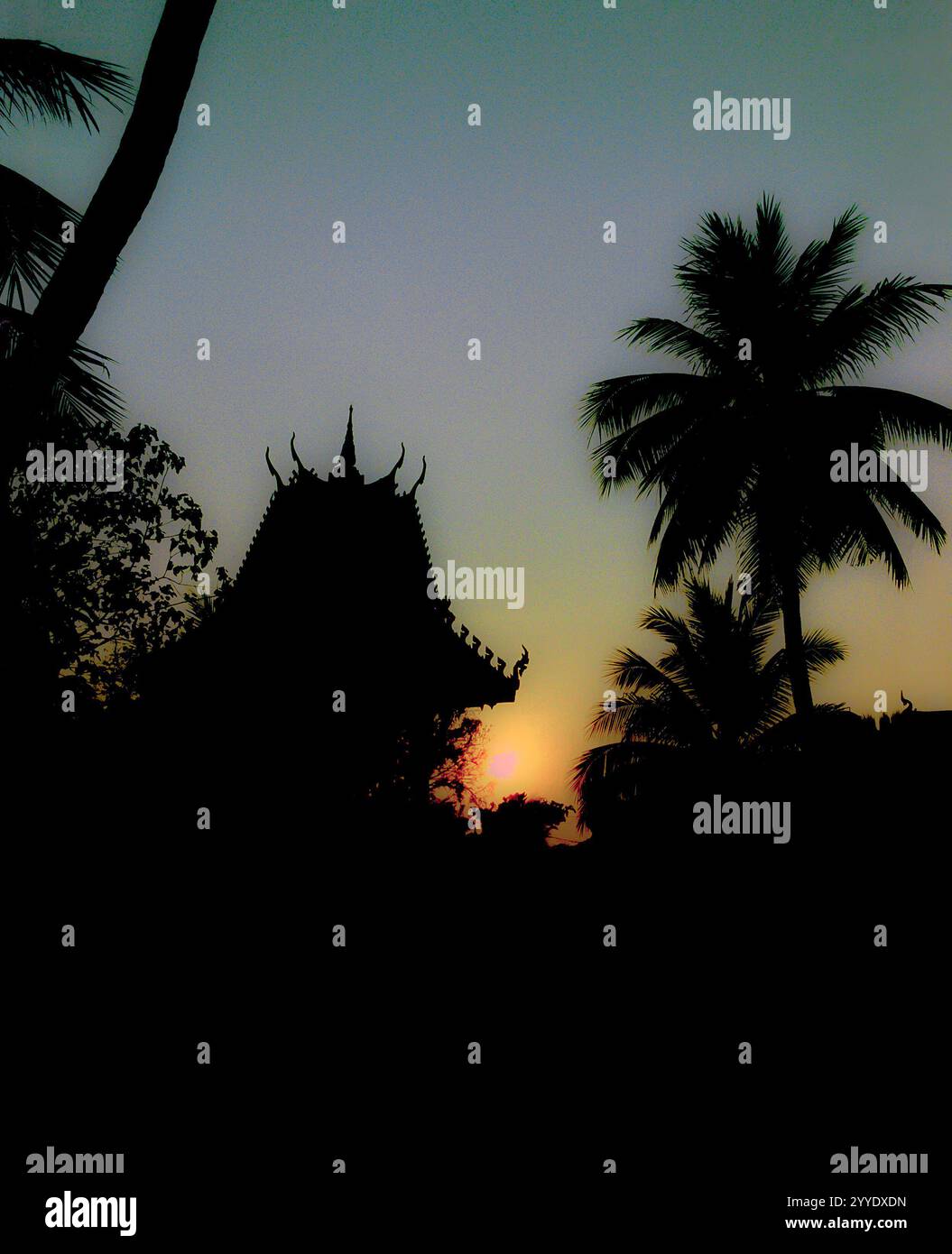 Laos, Si Phan Don: silhouettes of Wat Phuang Kaew at sunset Stock Photo ...