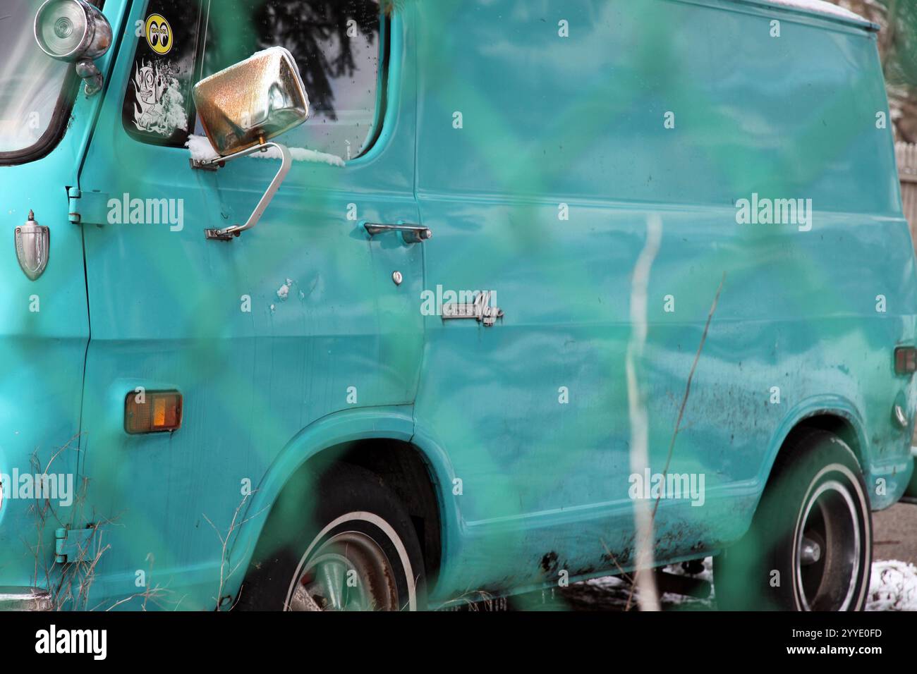 Old Chevy 90 van, behind chain link fence Stock Photo - Alamy