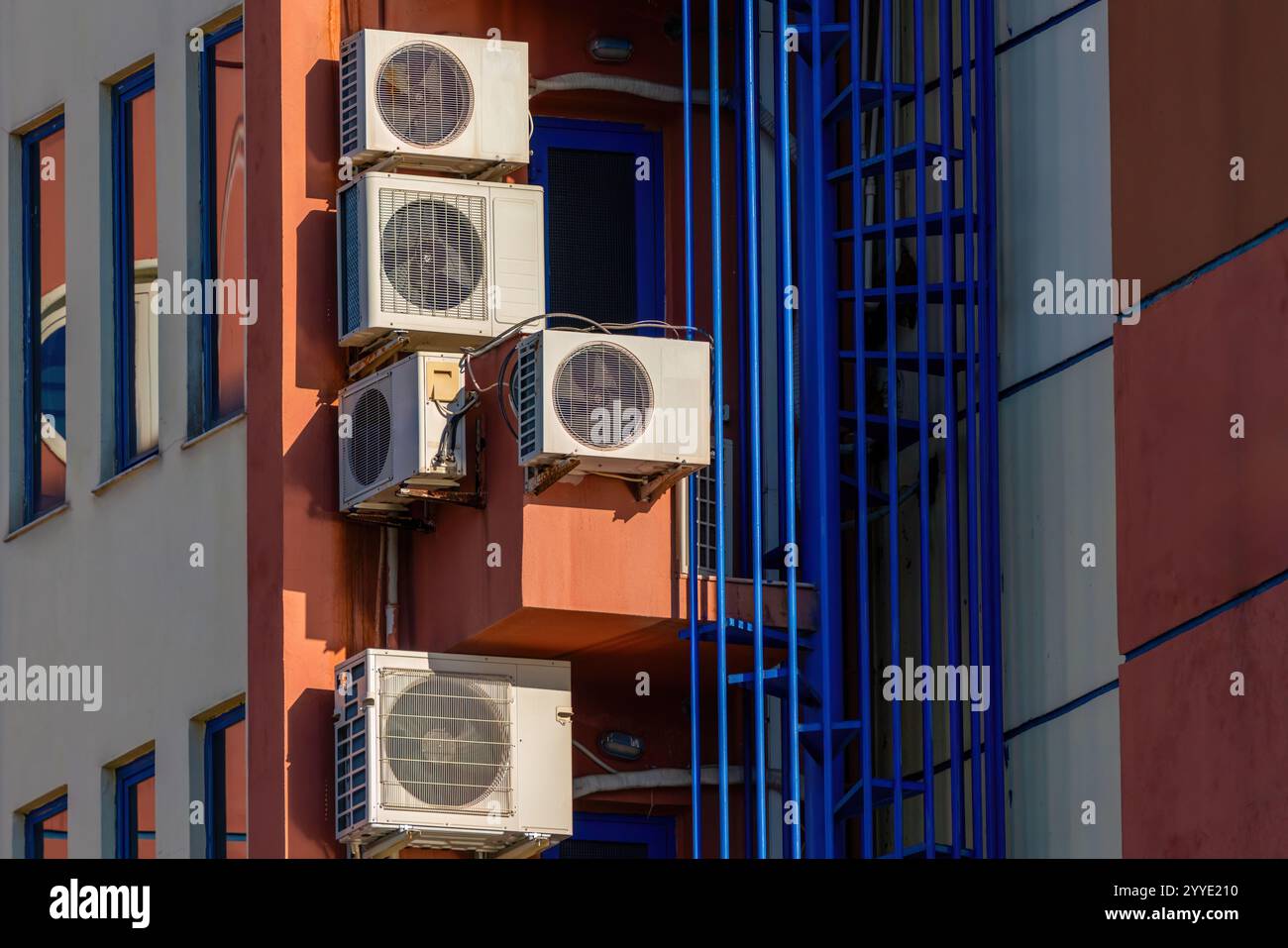 External units of split air conditioners hung outside the building ...