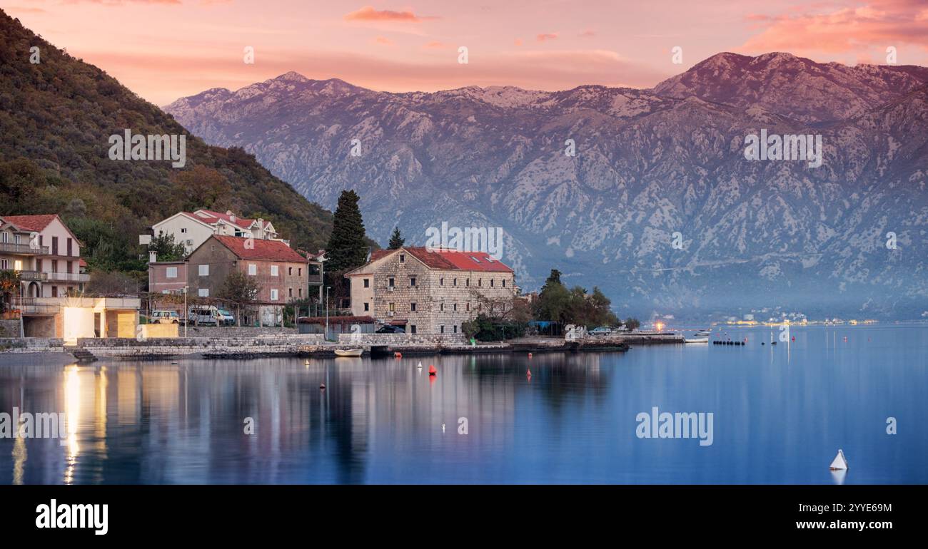 Tranquil coastal scene showcasing colorful sunset reflecting on calm ...