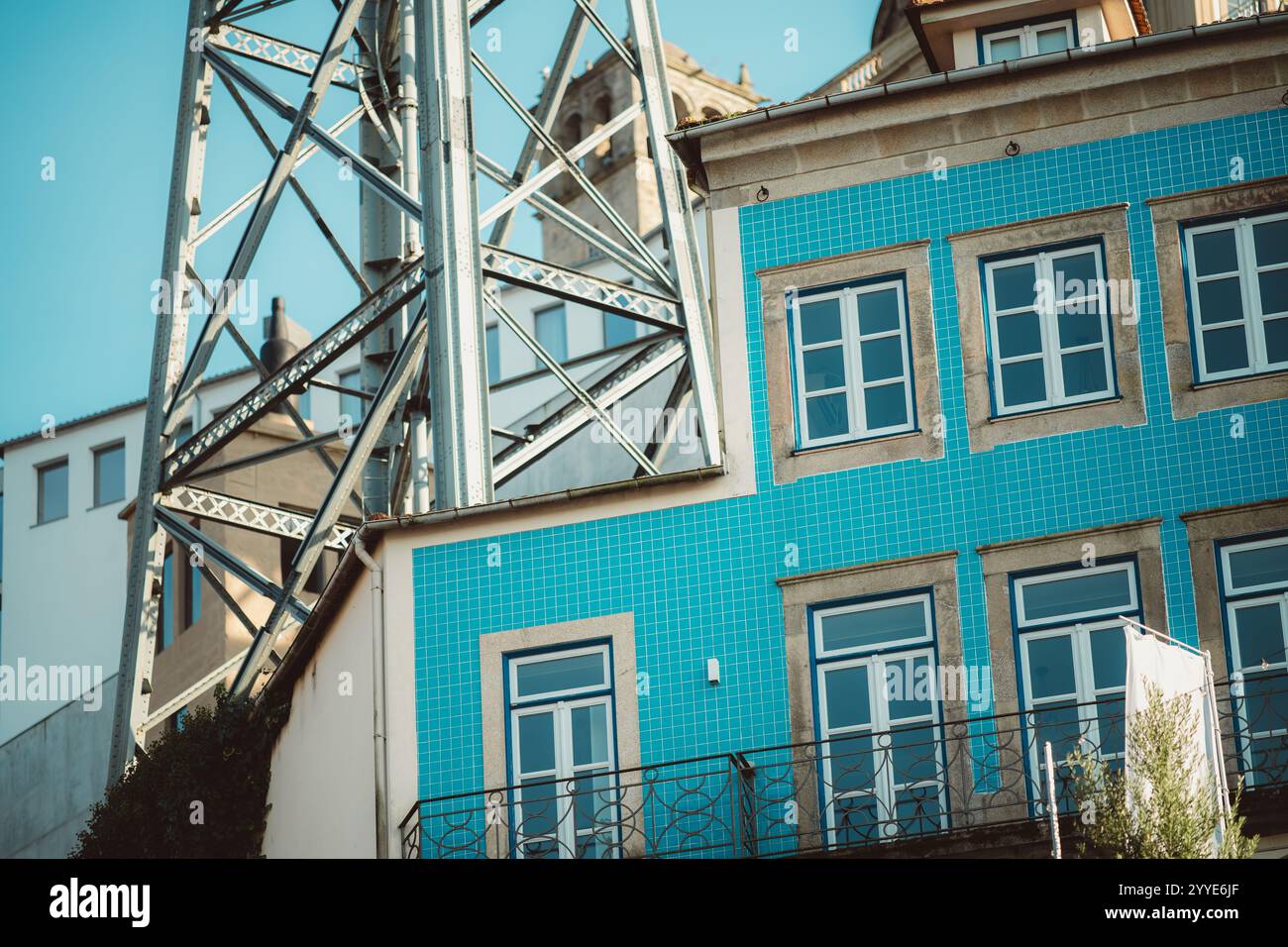 A telephoto shot of a vibrant blue-tiled building facade with ...