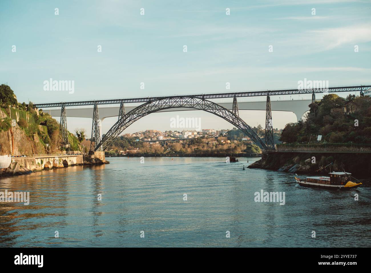 The Dona Maria Pia Bridge spans the Douro River in Porto, Portugal ...