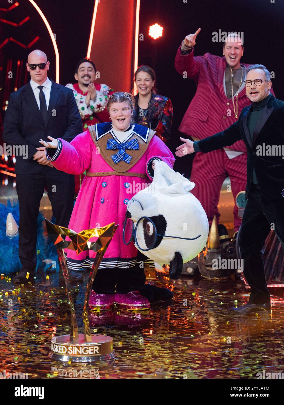 Cologne, Germany. 21st Dec, 2024. Singer Loi stands next to the trophy ...