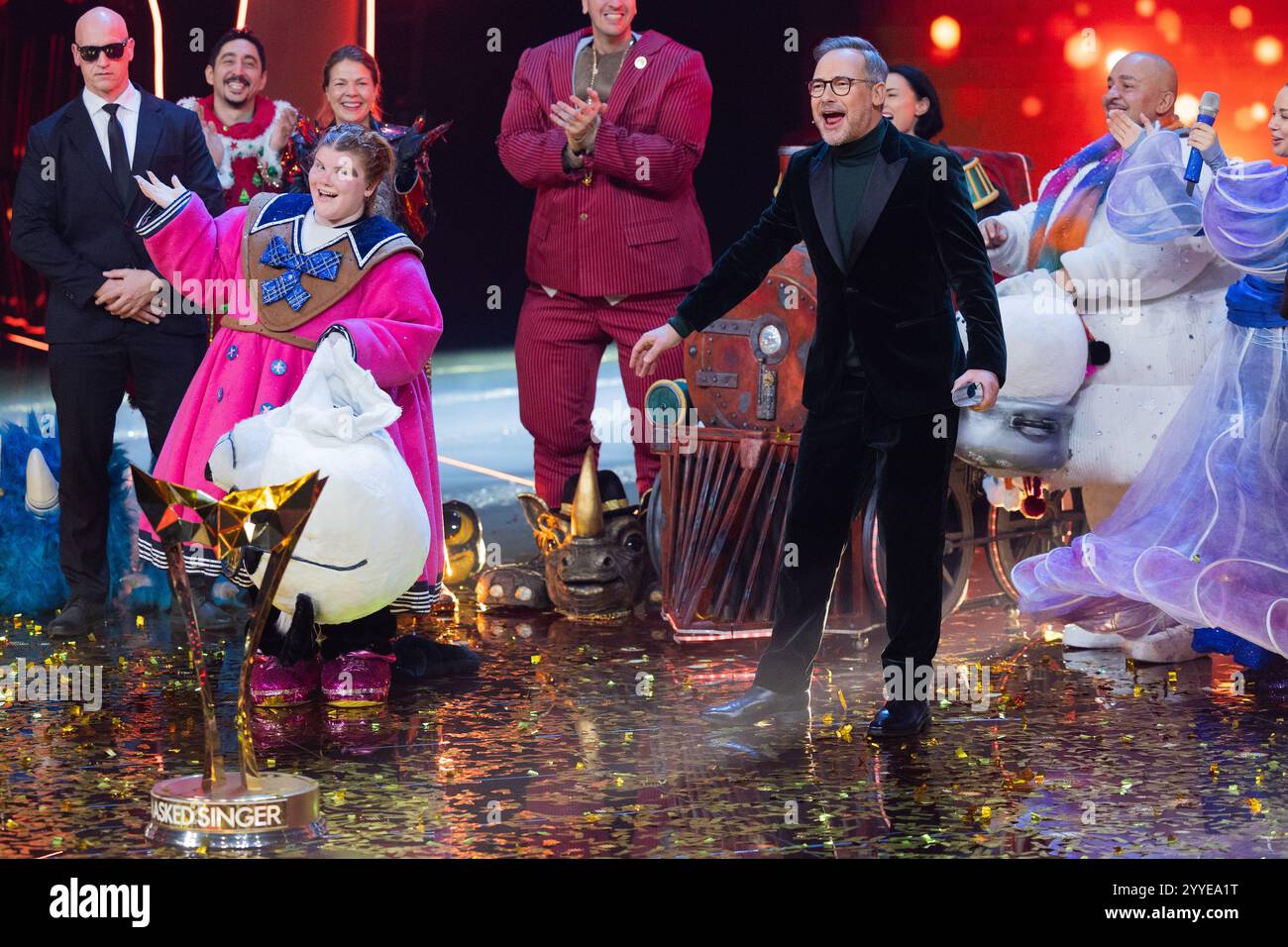 Cologne, Germany. 21st Dec, 2024. Singer Loi stands next to the trophy ...