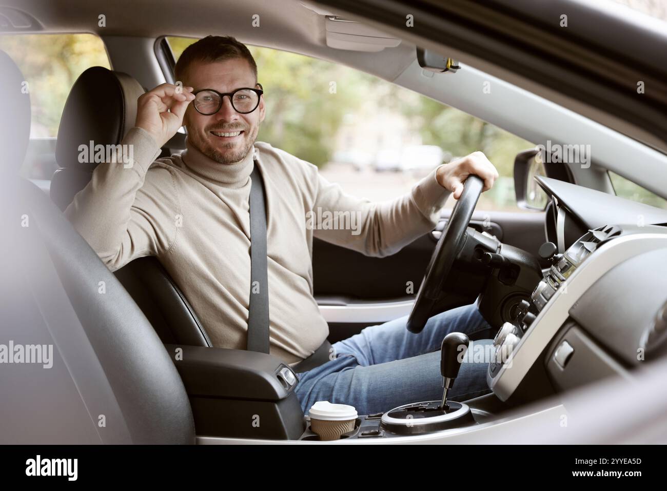 Happy man behind steering wheel of modern car Stock Photo - Alamy