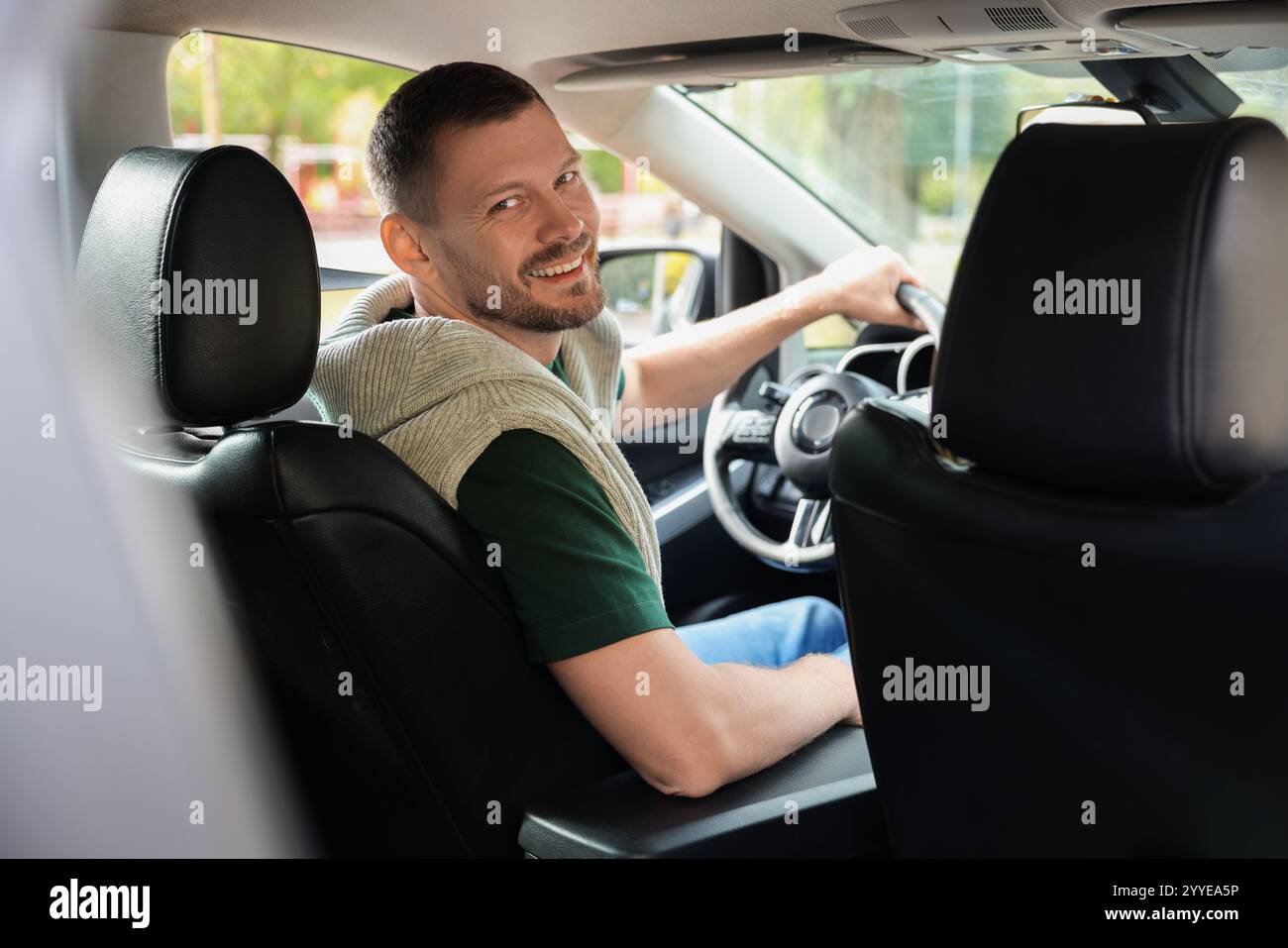 Happy man behind steering wheel of modern car Stock Photo - Alamy