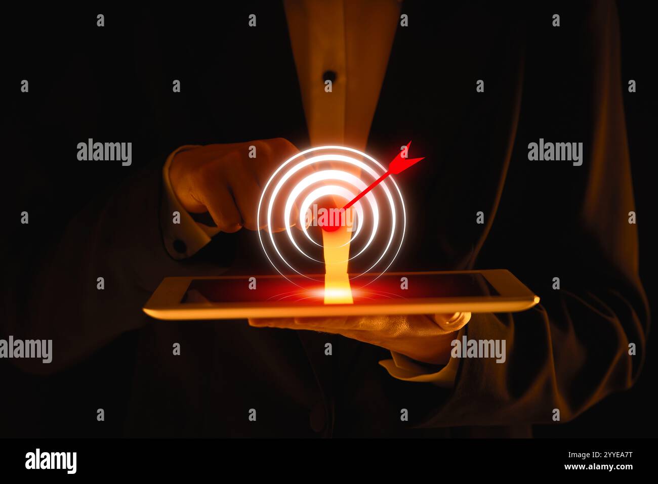 Businessman touching virtual target with arrow over tablet in his hand ...