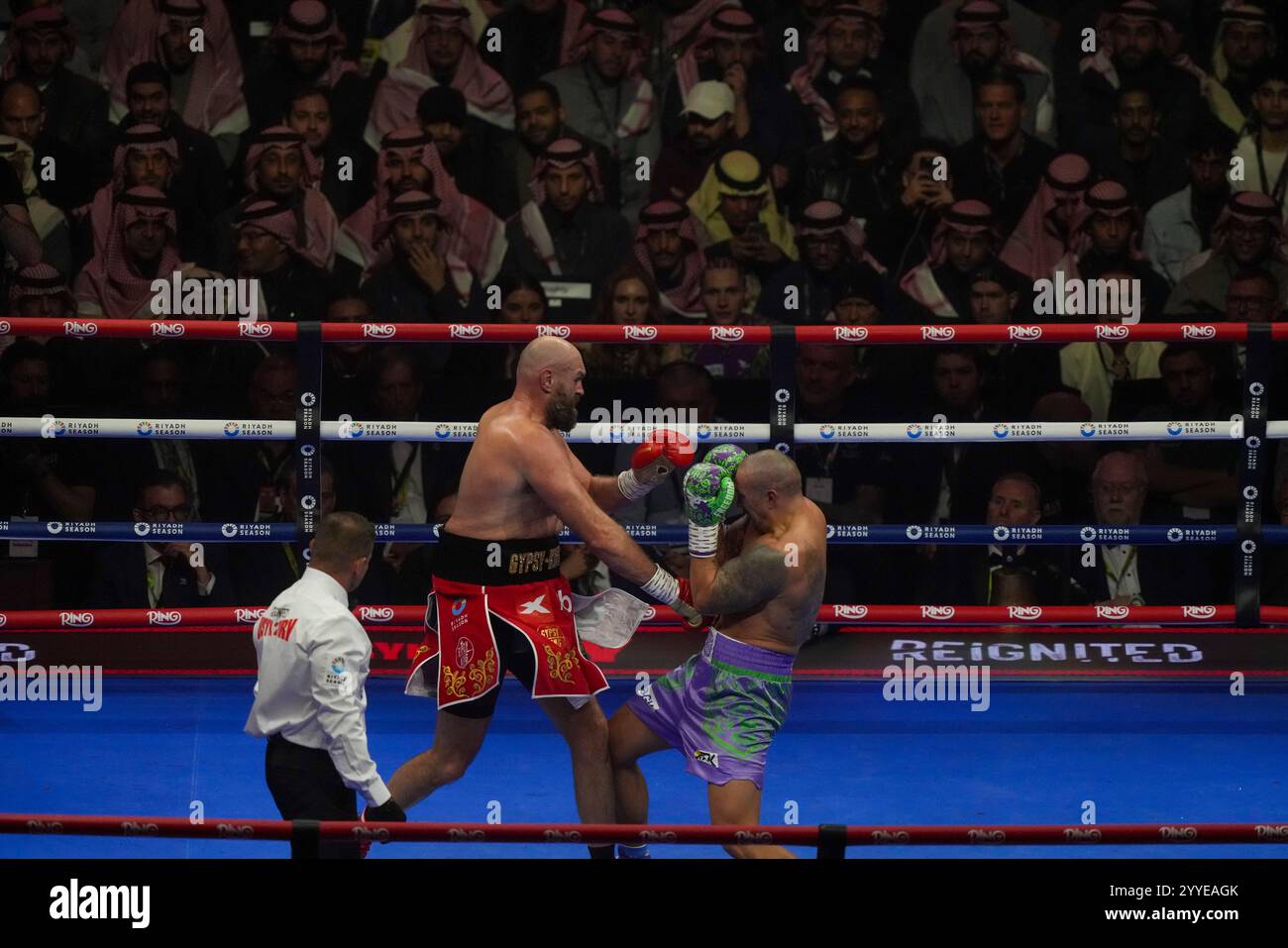 Boxers Britain's Tyson Fury, left, and Ukraine's Oleksandr Usyk compete during their WBA, WBO ...