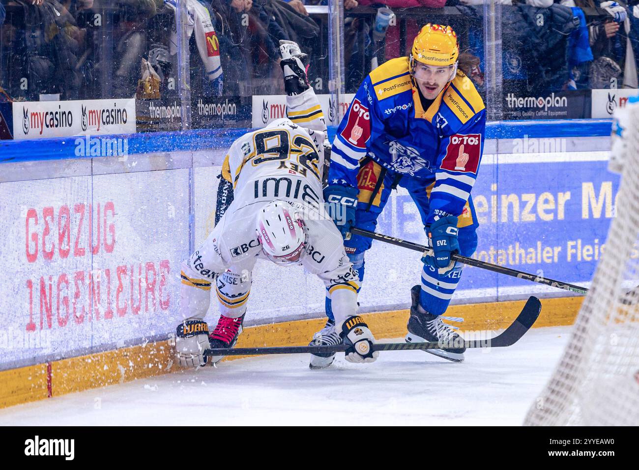 Top scorer Daniel Vozenilek (EV Zug) puts Kevin Fey #26 (HC Ajoie) on ...