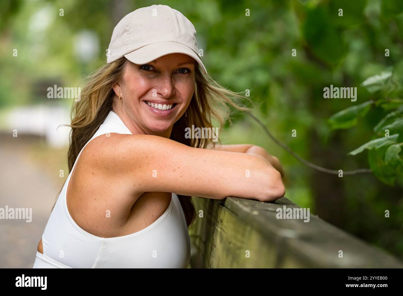 A gorgeous blonde model, dressed in sleek workout clothes, takes a well ...