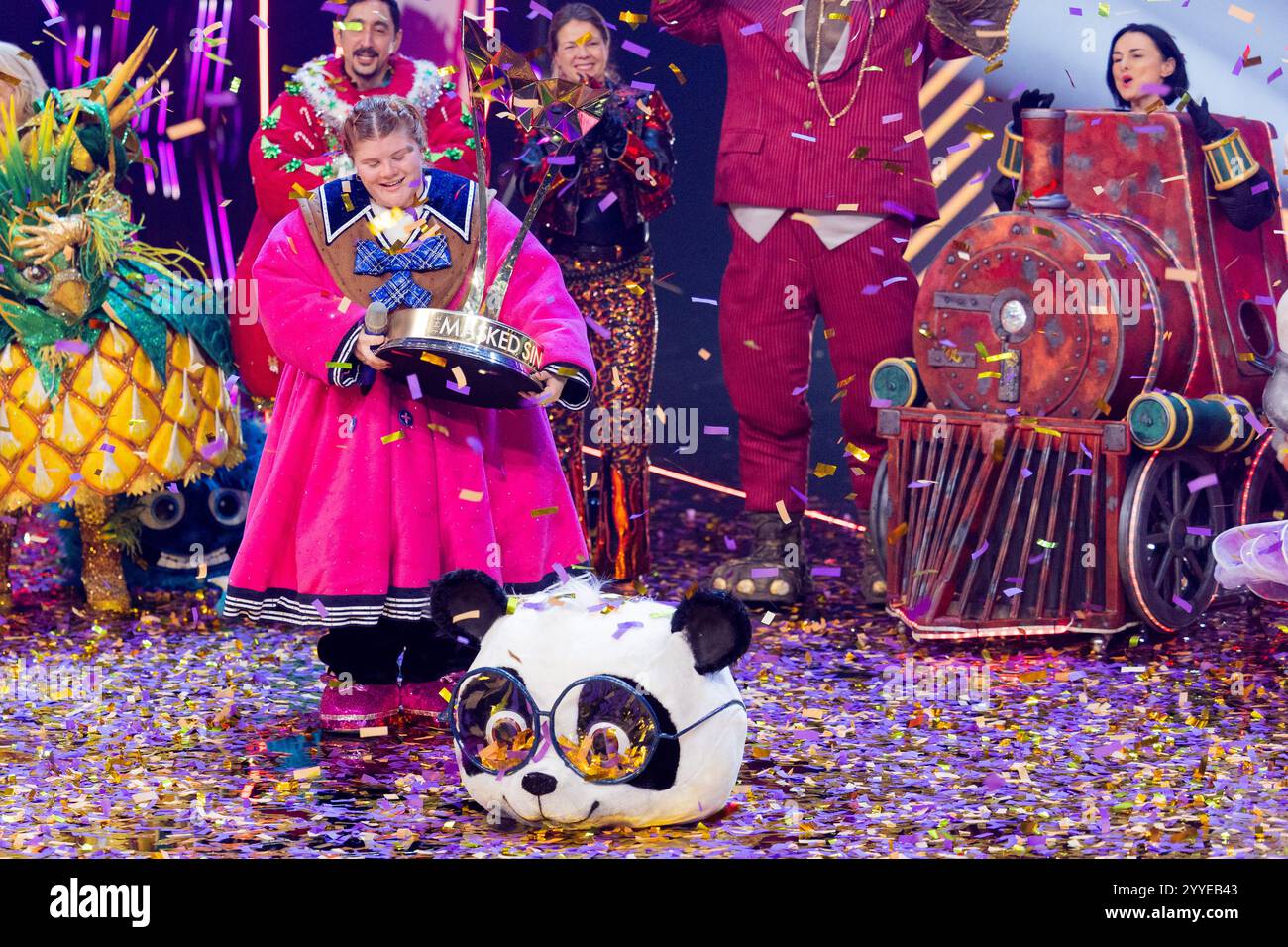 Cologne, Germany. 22nd Dec, 2024. Singer Loi stands next to the trophy ...
