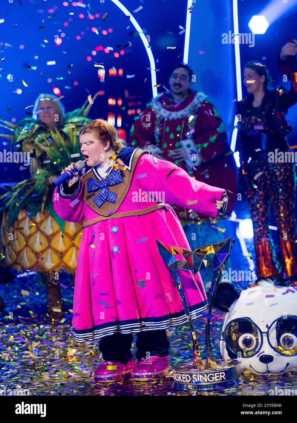 Cologne, Germany. 21st Dec, 2024. Singer Loi stands next to the trophy ...