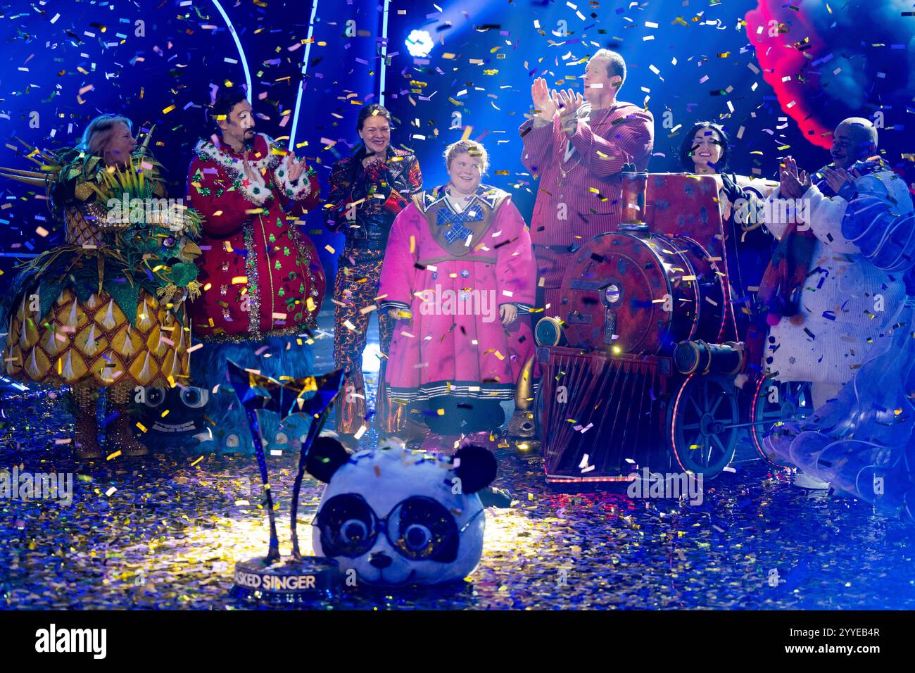 Cologne, Germany. 21st Dec, 2024. Singer Loi stands next to the trophy ...