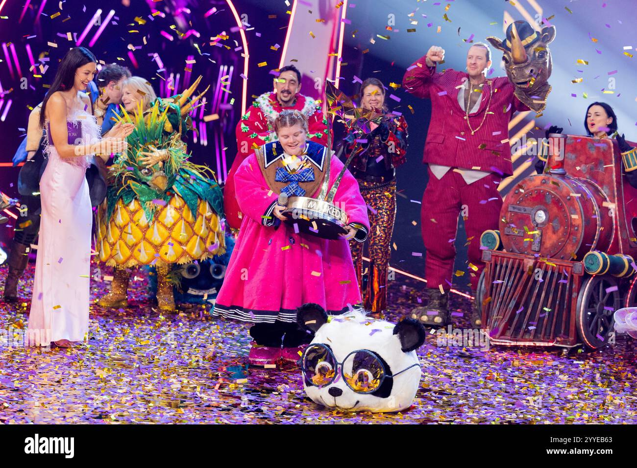 Cologne, Germany. 22nd Dec, 2024. Singer Loi stands next to the trophy ...