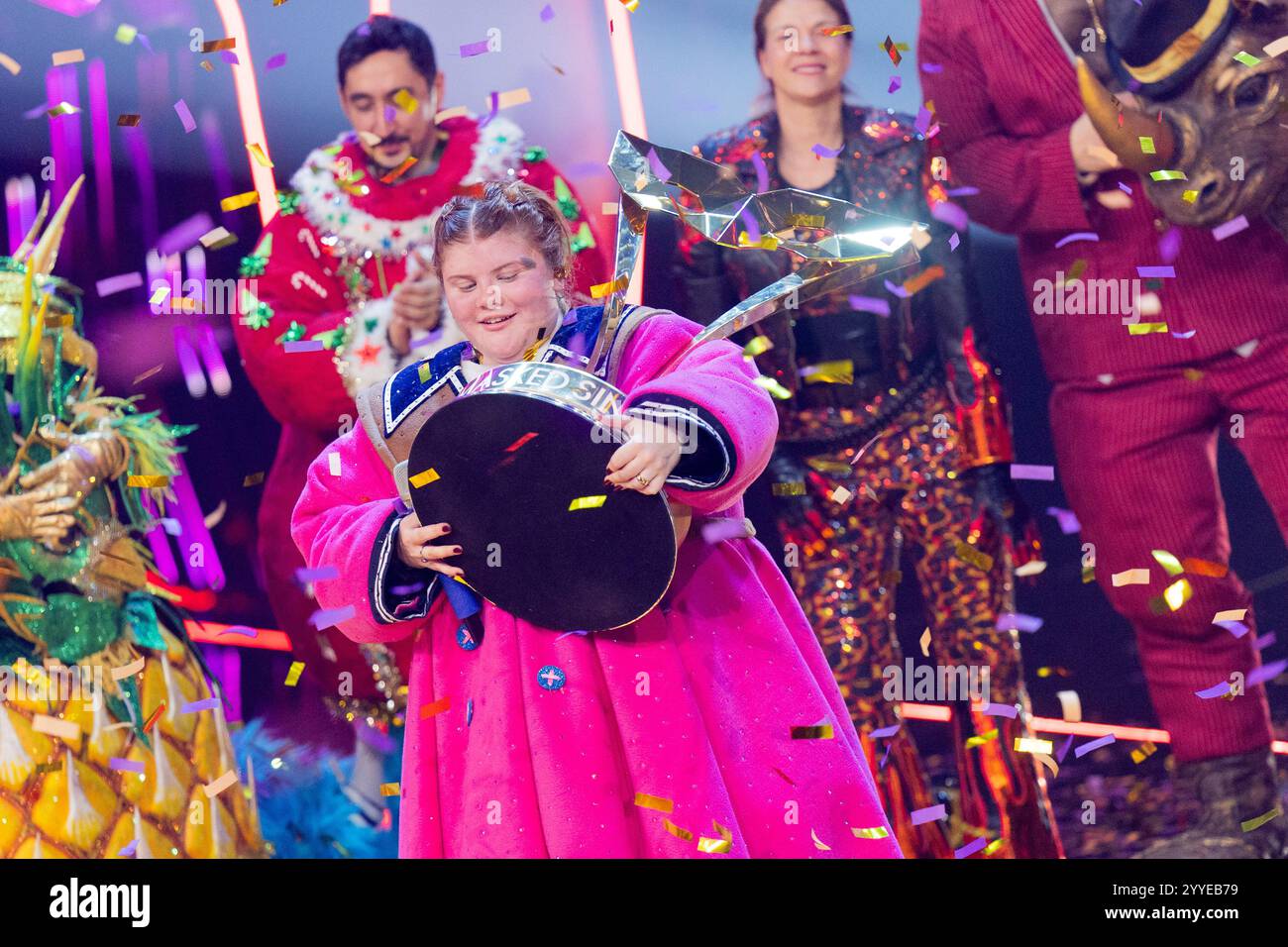Cologne, Germany. 22nd Dec, 2024. Singer Loi stands next to the trophy ...
