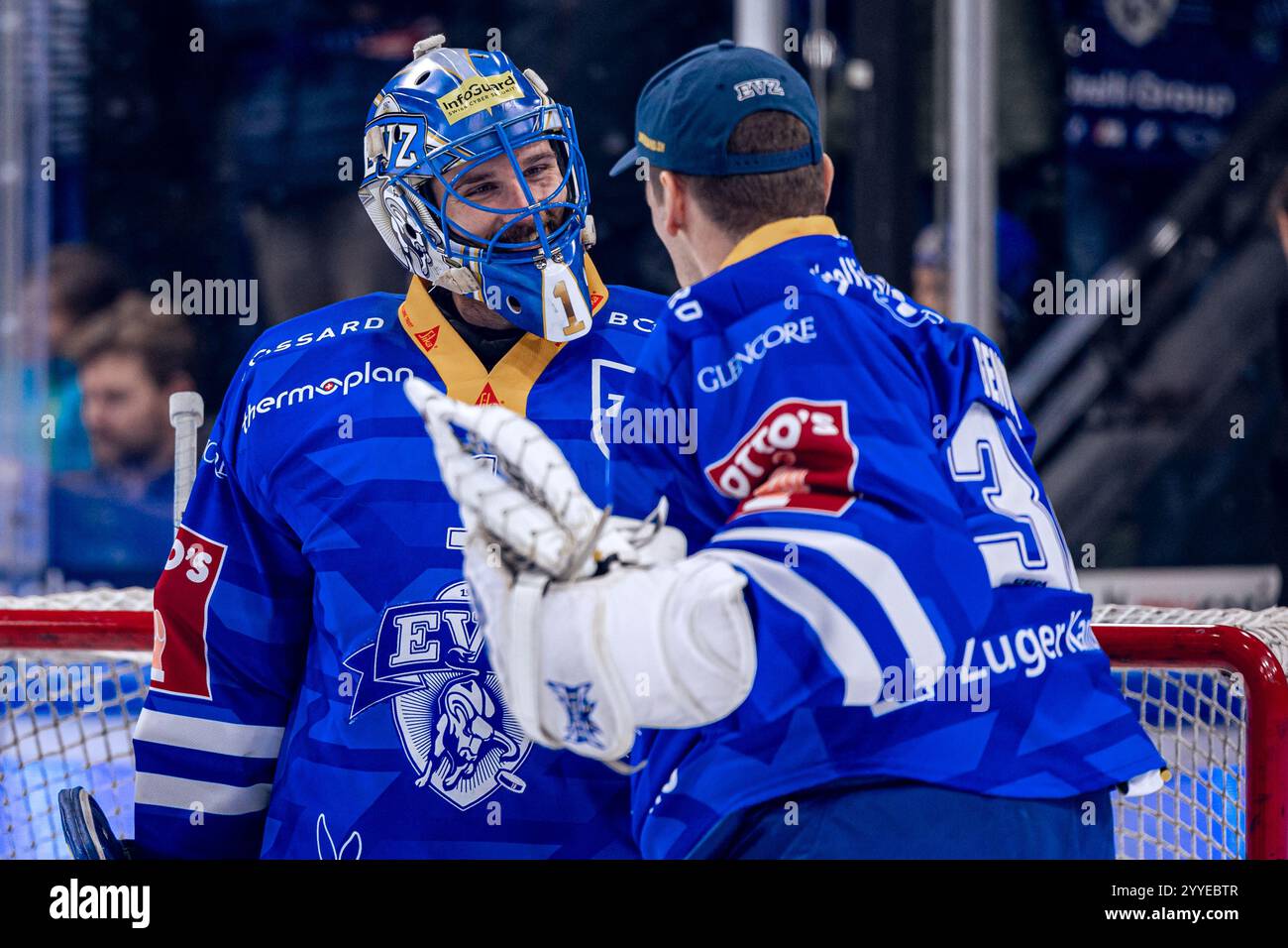 Goalkeeper Tim Wolf #1 (EV Zug) laughs with goalkeeper Leonardo Genoni ...