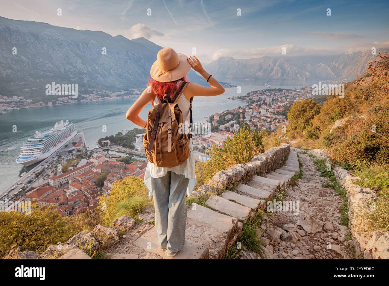 Female tourist descending ancient stone steps, savoring breathtaking ...