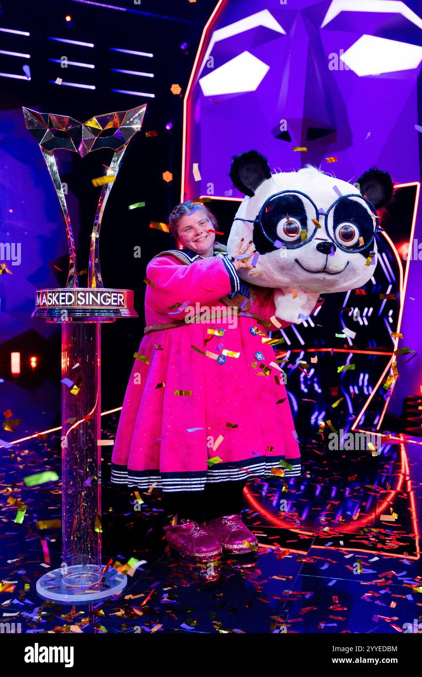 Cologne, Germany. 22nd Dec, 2024. Singer Loi stands next to the trophy ...