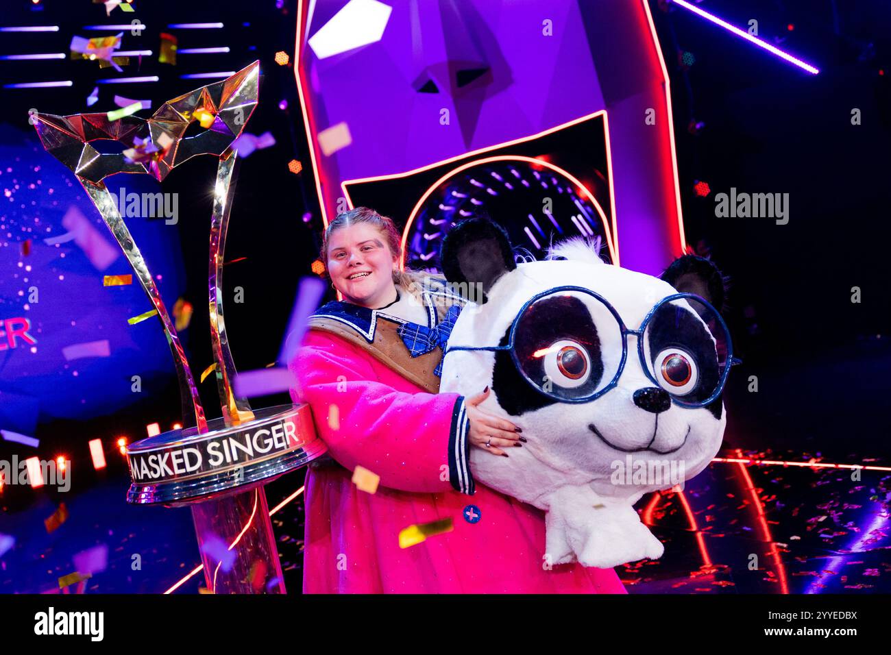 Cologne, Germany. 22nd Dec, 2024. Singer Loi stands next to the trophy ...