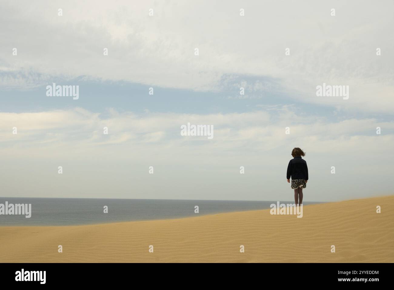 Girl Standing on Tottori Sand Dunes Overlooking the Ocean Stock Photo ...
