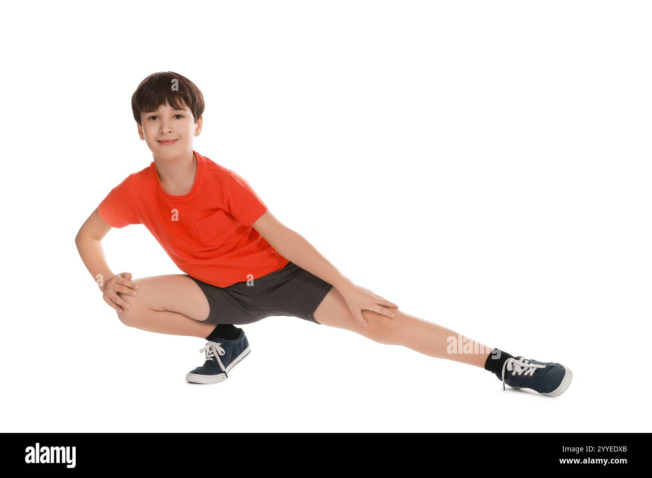 Boy doing exercise on white background. Sport activity Stock Photo - Alamy