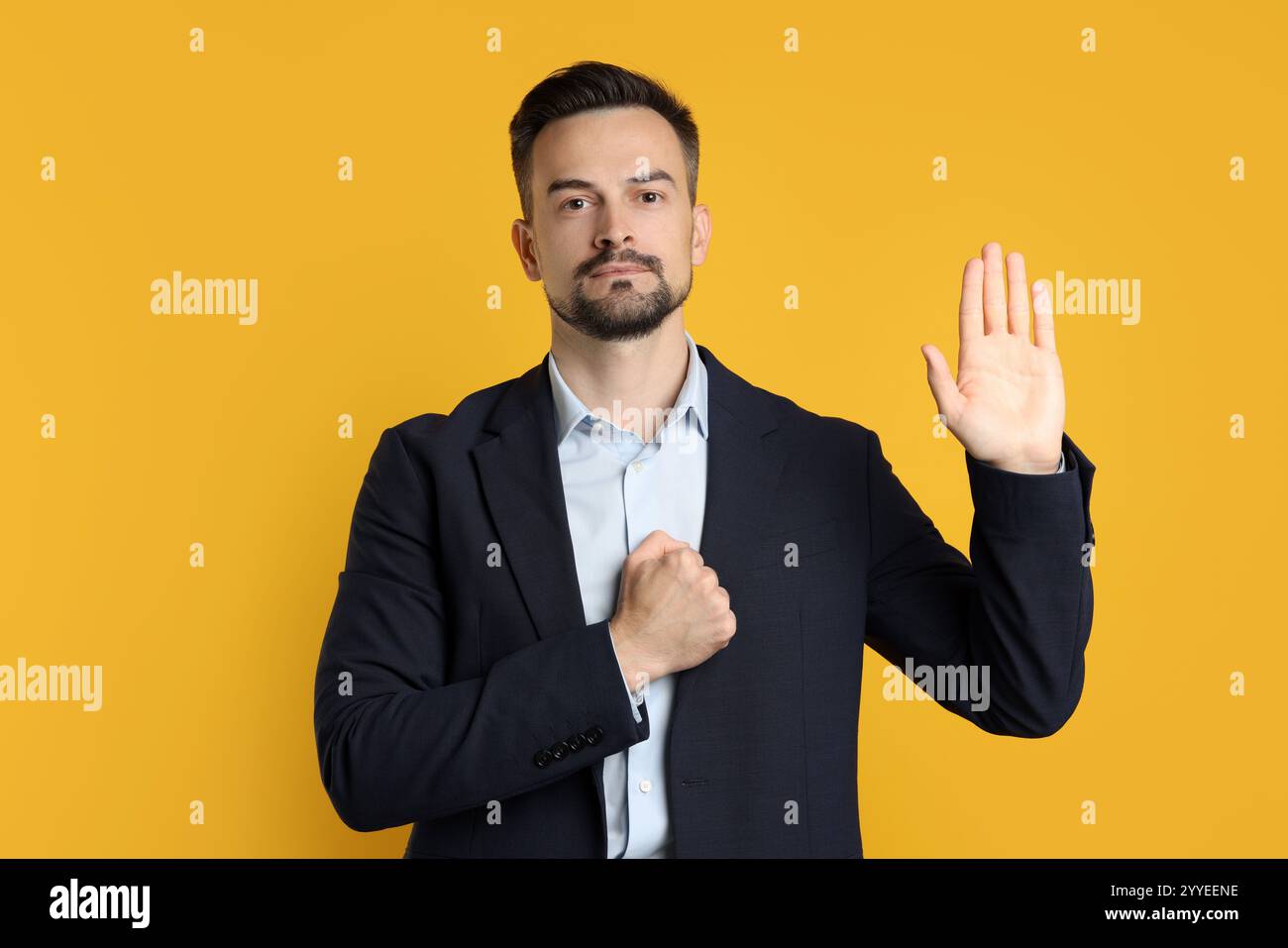 Man making oath with hand on chest hi-res stock photography and images ...