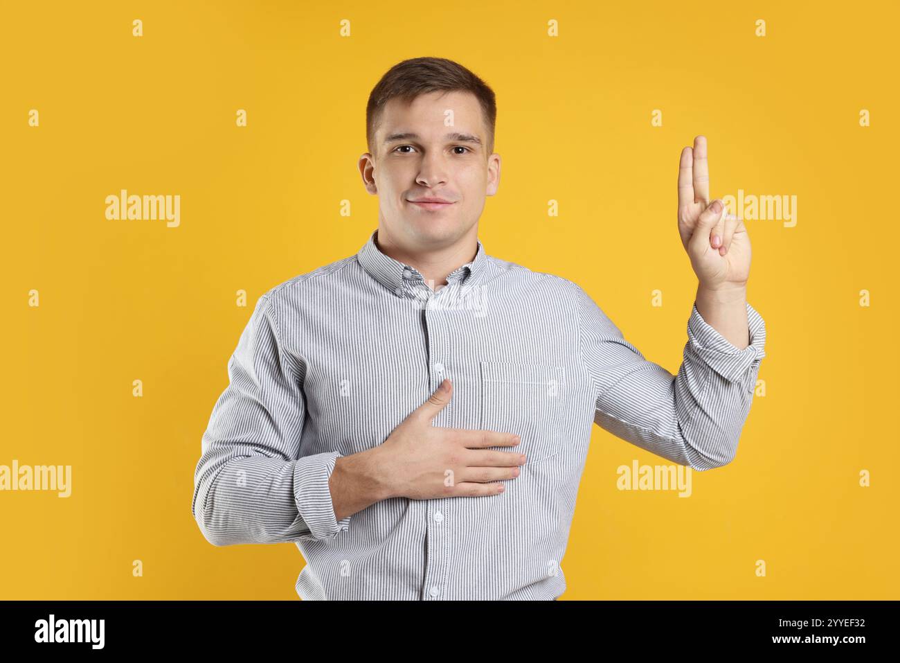 Man showing oath gesture on orange background. Making promise Stock ...
