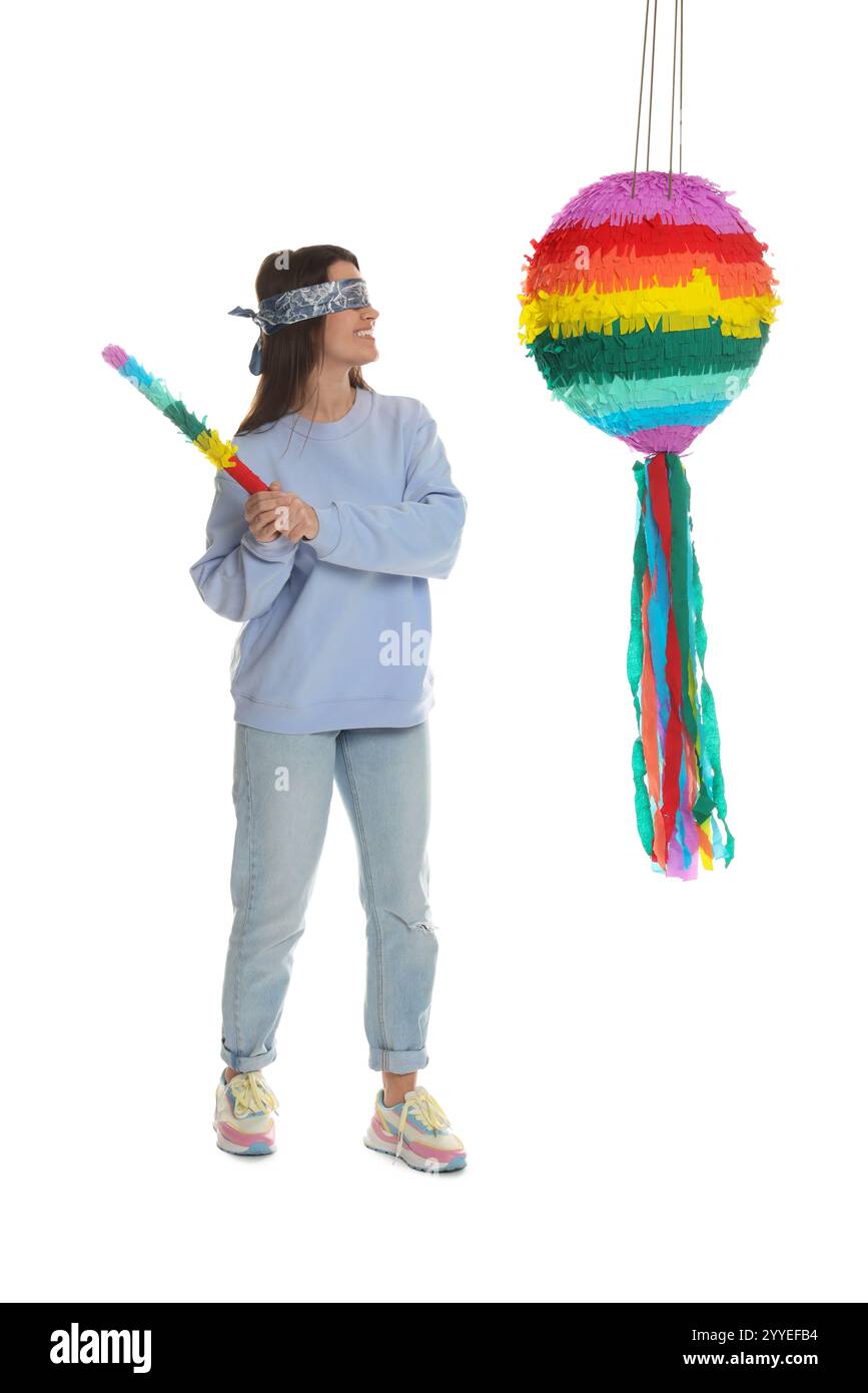 Woman with tied eyes breaking pinata on white background Stock Photo ...