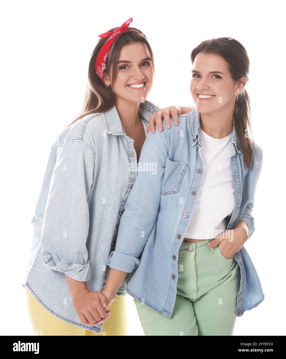 Portrait of beautiful twin sisters on white background Stock Photo - Alamy