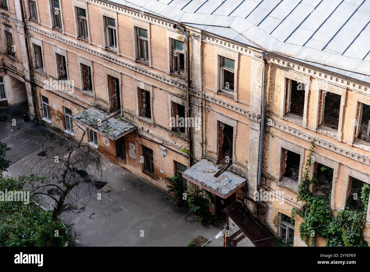The building is old and abandoned. The windows are boarded up and the ...