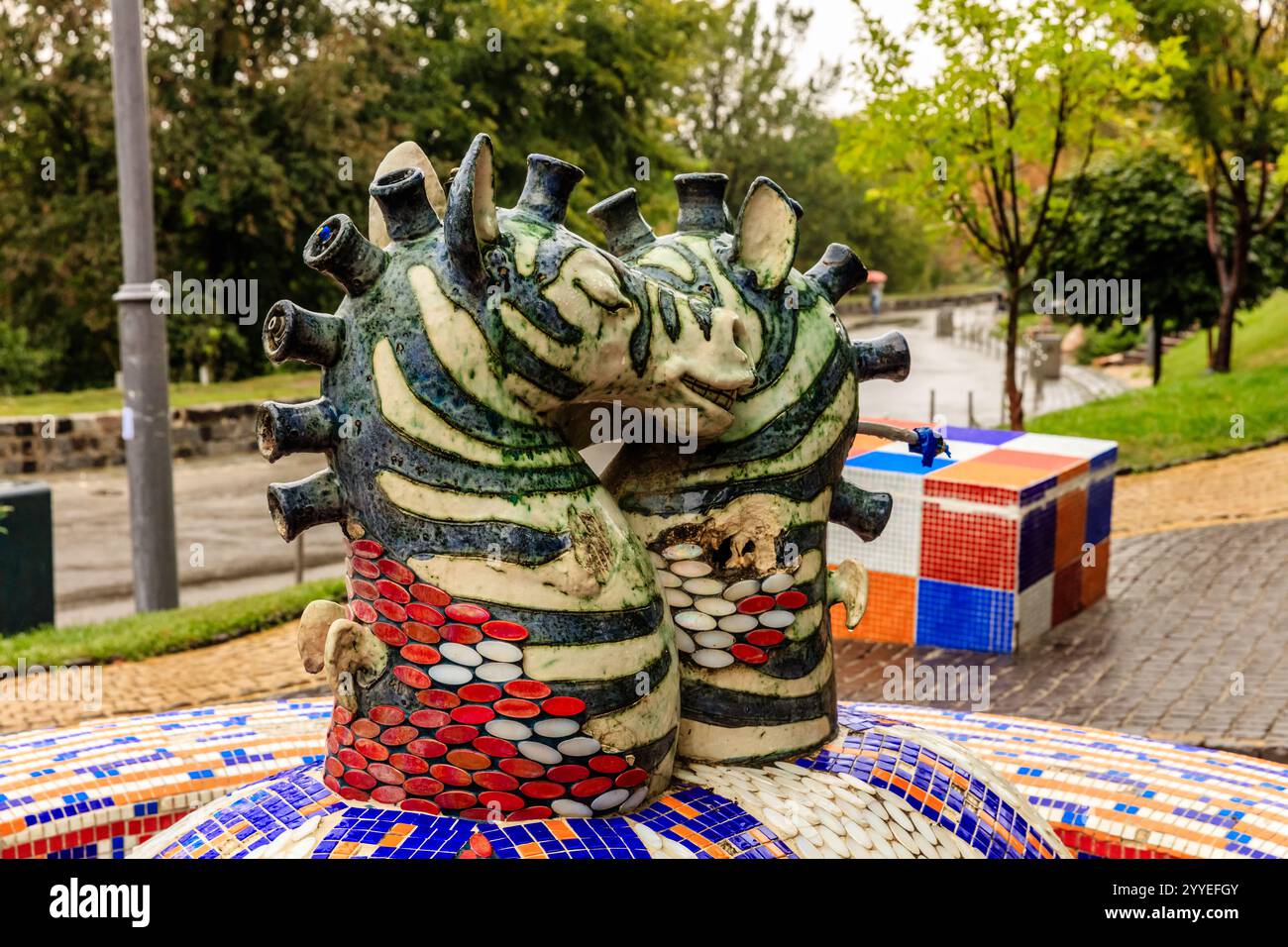 Two zebra statues are sitting on a fountain. The statues are made of ...