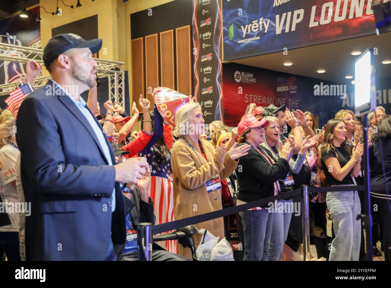 Phoenix, USA. 21st Dec, 2024. People cheer as they gather around to ...