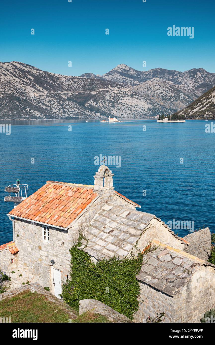 stone-chapel-with-terracotta-roof-and-bell-tower-stands-on-the-shore