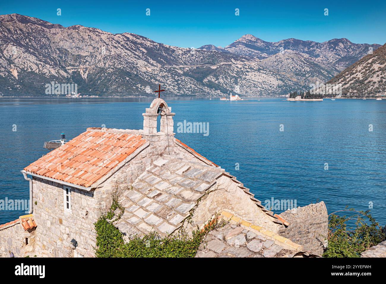 Stone Chapel With Terracotta Roof And Bell Tower Stands On The Shore